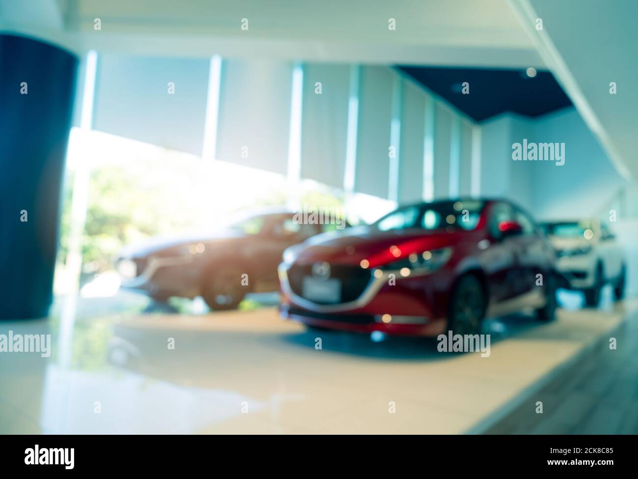 Blurred SUV car parked in modern showroom. Car dealership and auto ...