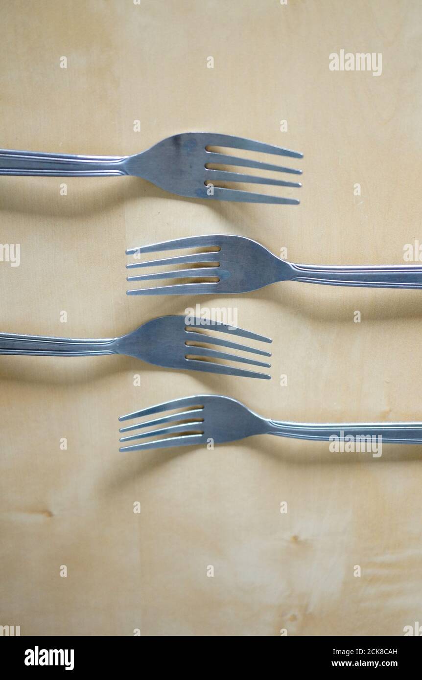 Four forks on the wooden surface Stock Photo - Alamy