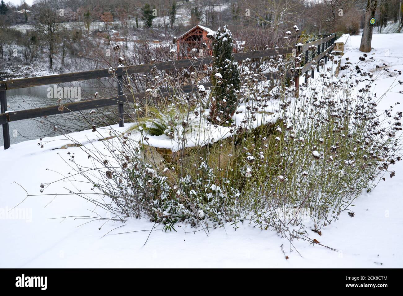 Village house near the lake in the snow. Snowy Winter rustic landscape ...