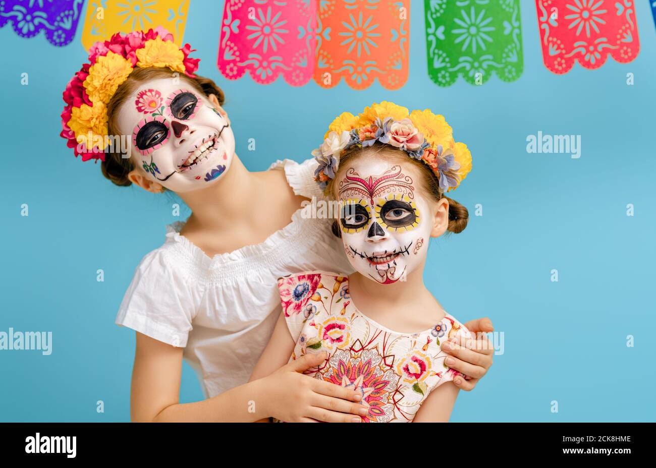 Adorable zombies in flower wreaths posing on blue background. Happy ...