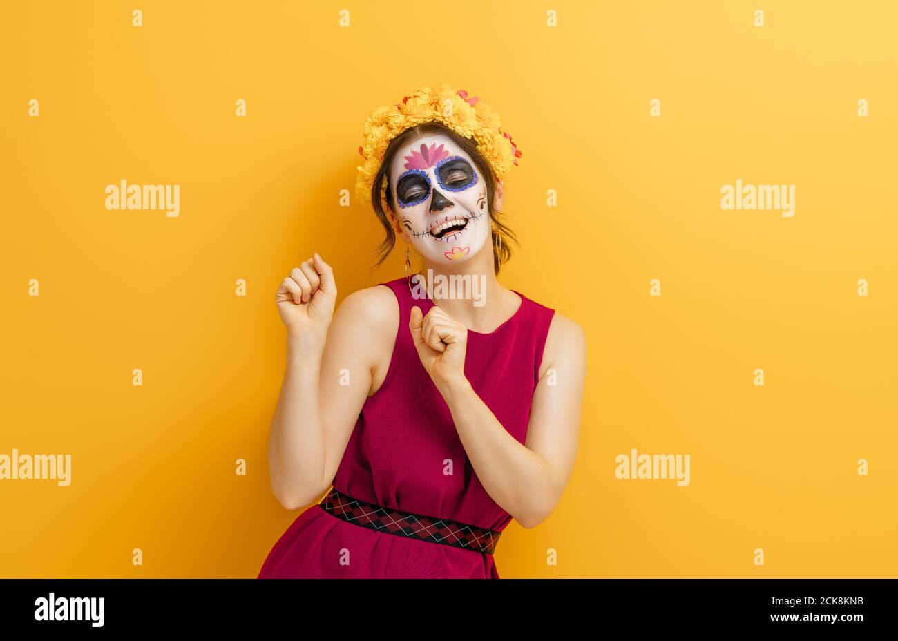 Adorable zombie in flower wreath posing on yellow background. Happy ...