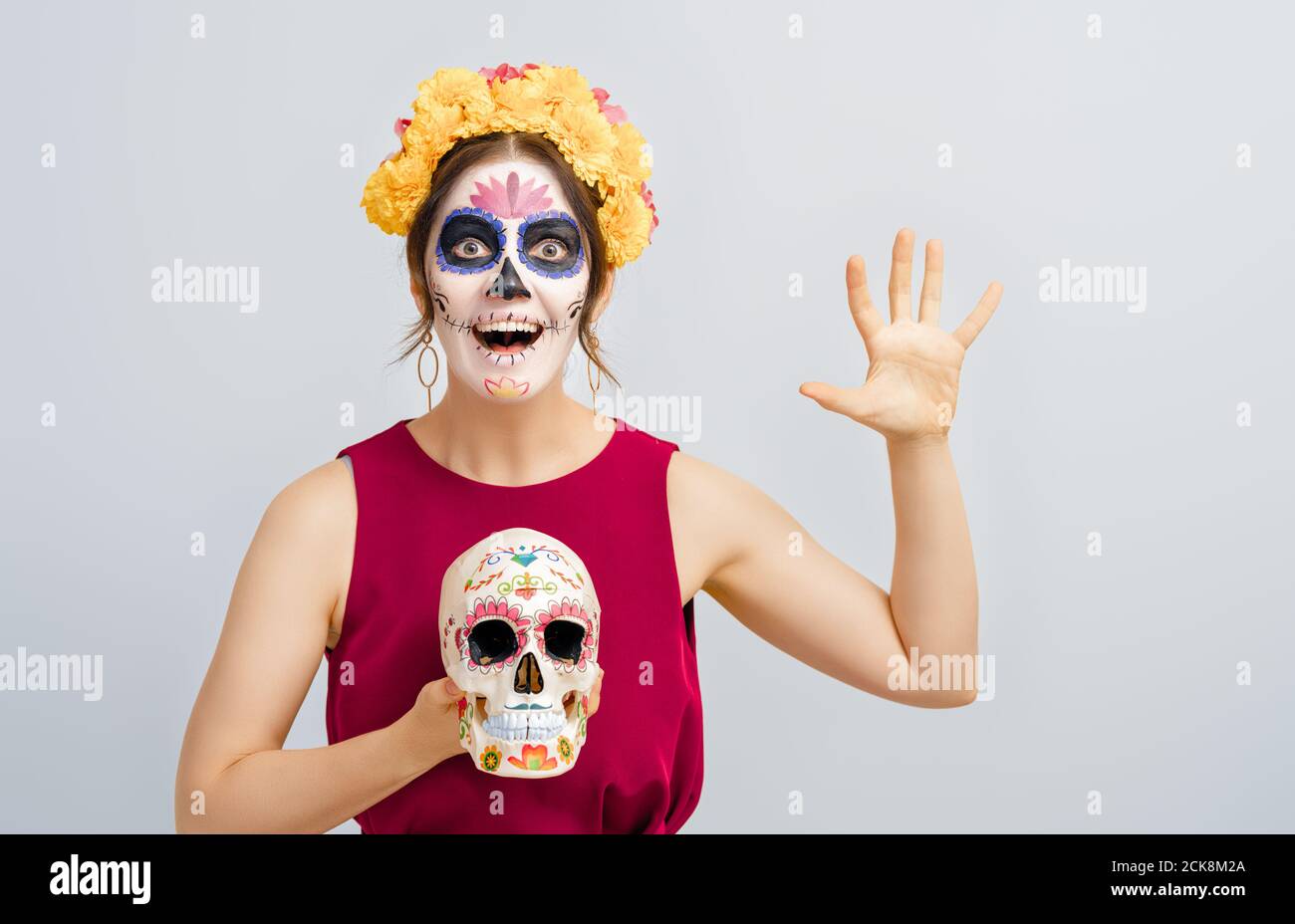 Adorable zombie in flower wreath posing on white background. Happy ...