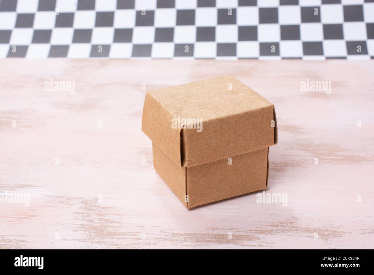 Small paper box on a wooden surface Stock Photo - Alamy