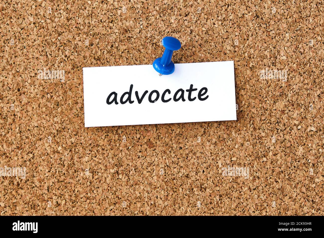 Advocate. Word written on a piece of paper or note, cork board ...