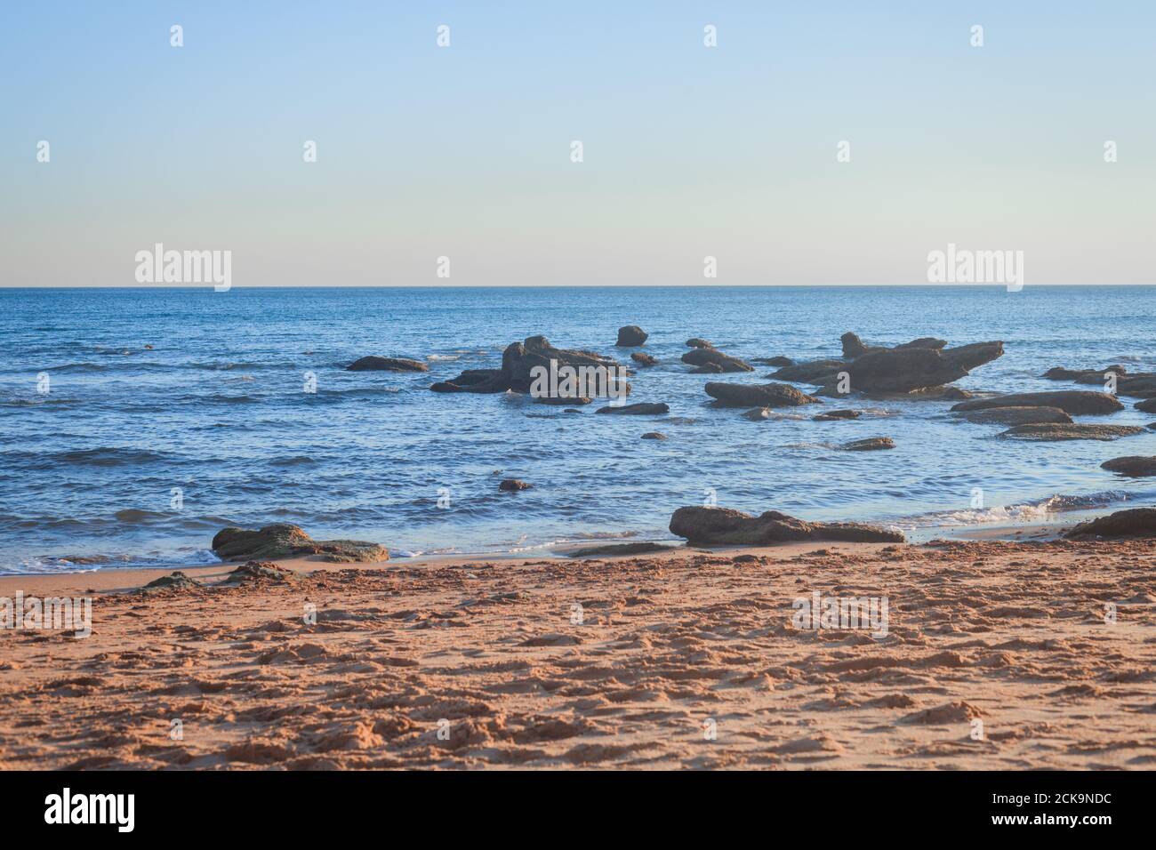 Beautiful view of a sandy shore with a clear skyline Stock Photo - Alamy