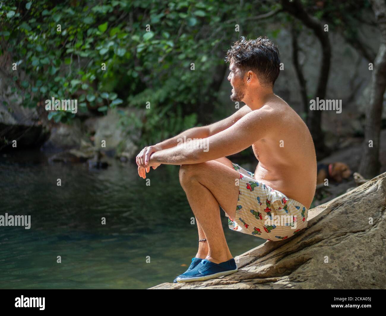 Guy sitting on rocks hi-res stock photography and images - Alamy