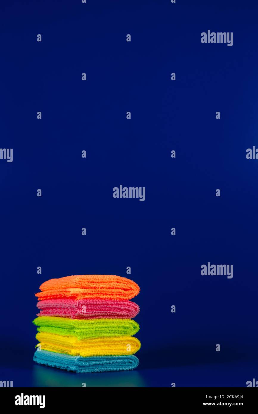 different color rags on a blue background Stock Photo - Alamy