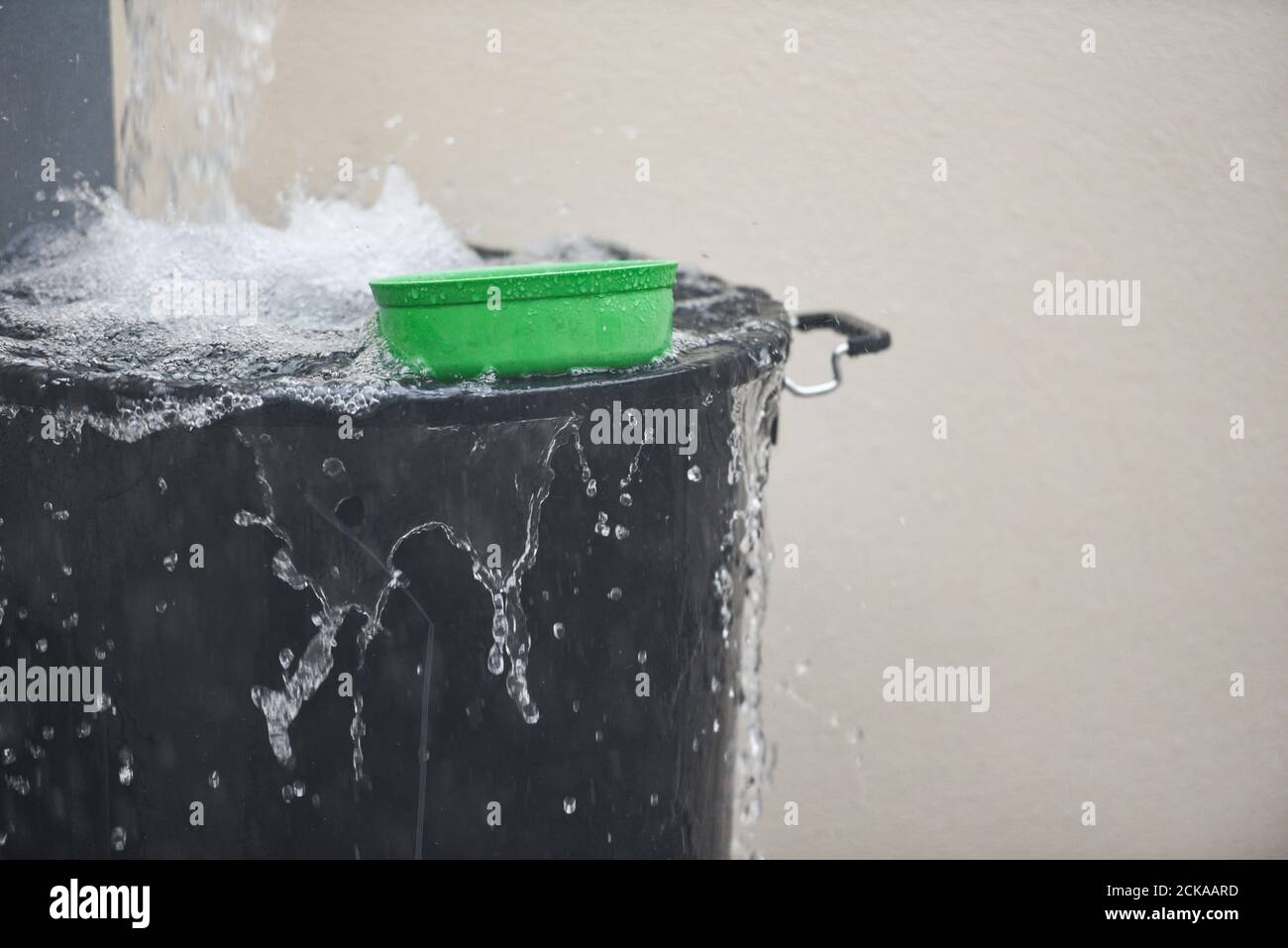 Bucket with water splashes rain water harvesting in the bucket of water ...