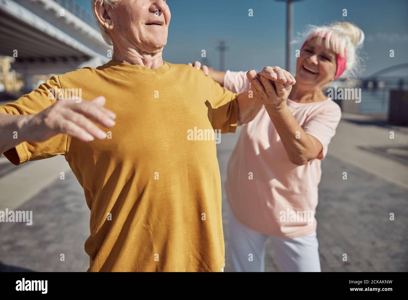 Elderly man performing a warm-up exercise outdoors Stock Photo - Alamy
