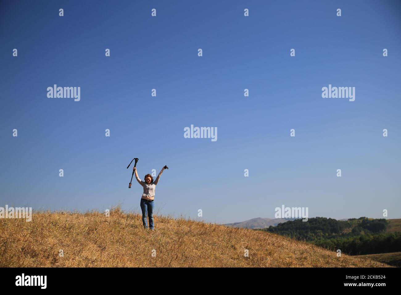 Girl in the field alone with the camera Stock Photo - Alamy