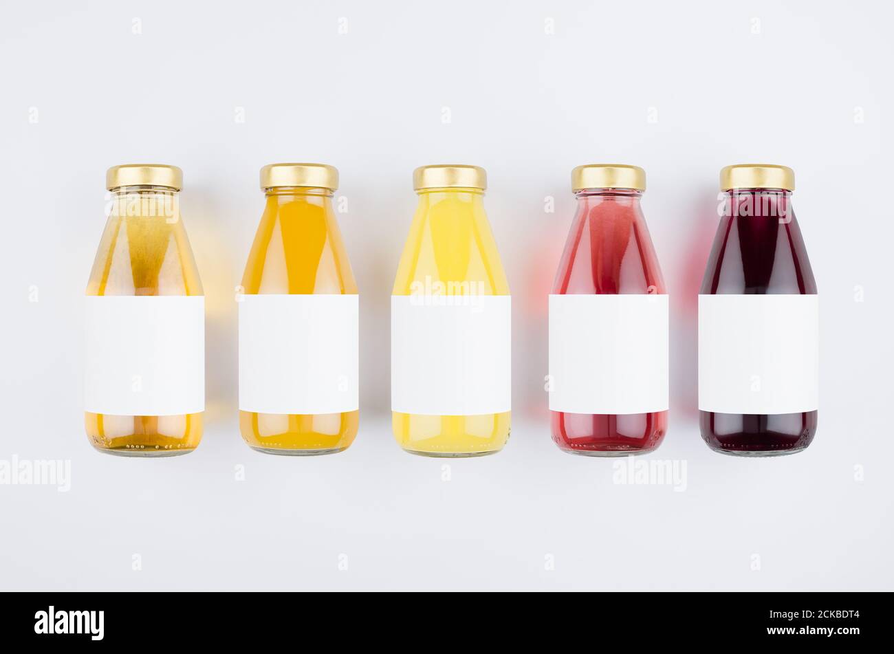 Organic fruits juices - set of different color juices with cap in glass ...