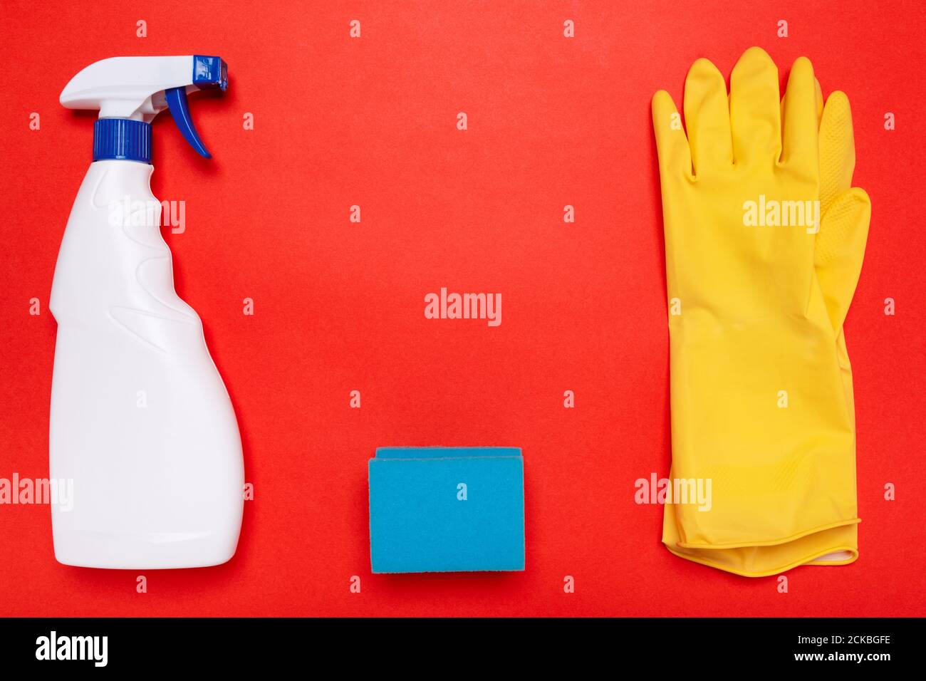 white wiper yellow gloves and blue sponge on a red background ...