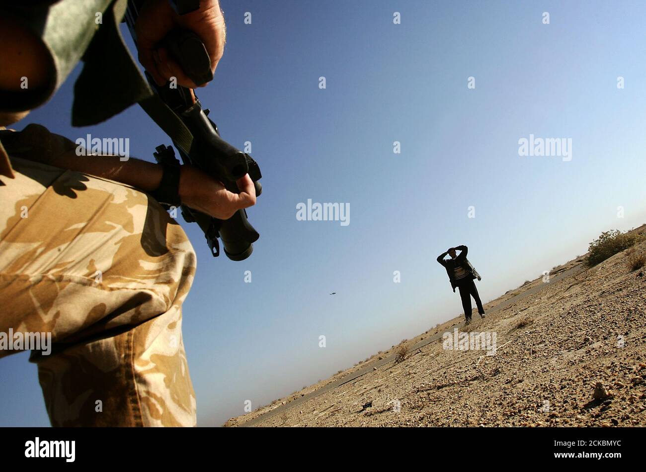 A british soldier stops an iraqi civilian at a check point hi-res stock ...