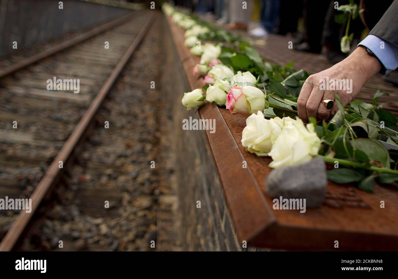 A person lays flowers at the Platform 17 memorial at Grunewald railway ...