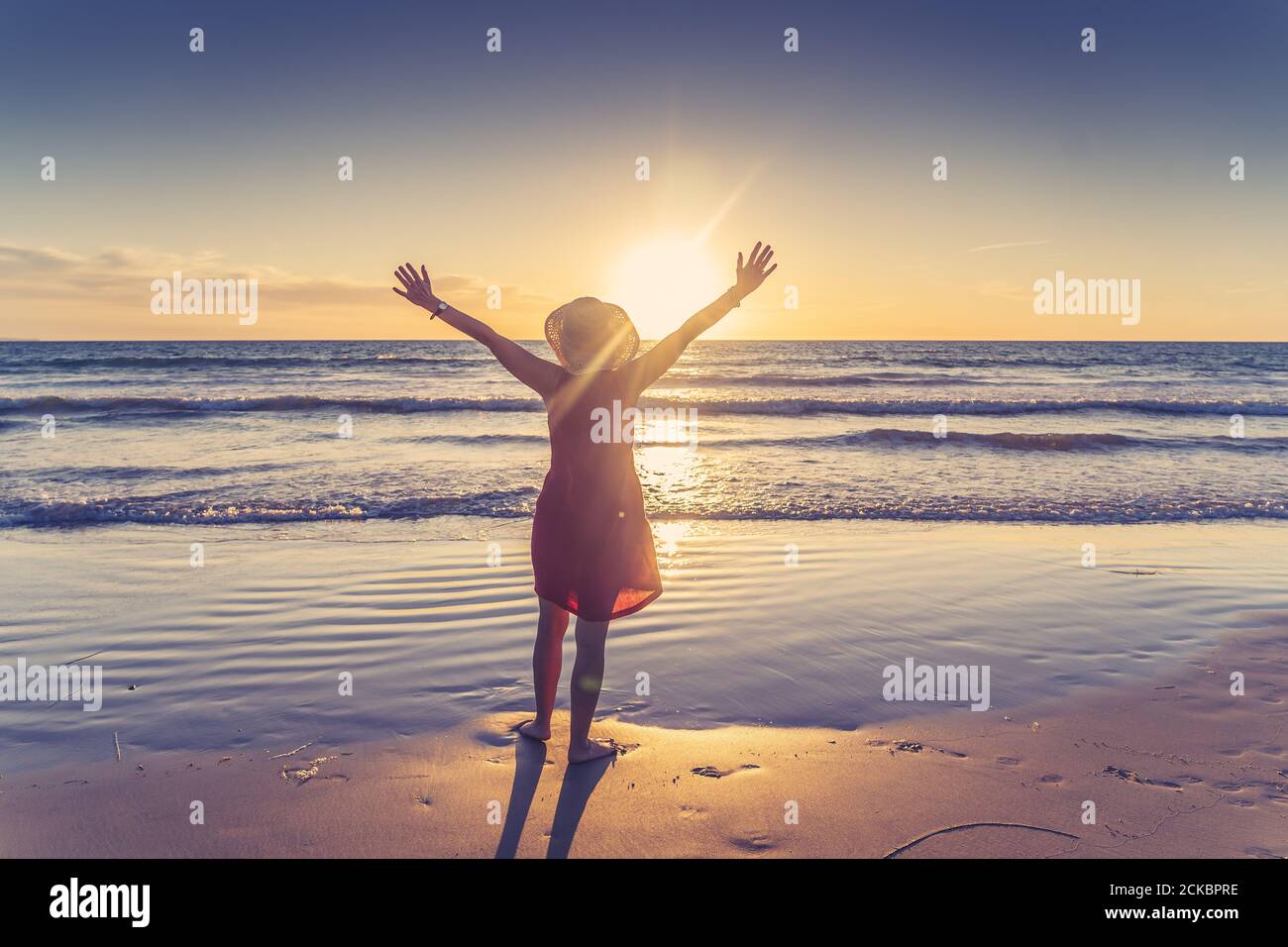 Happy attractive Mature woman in red dress enjoying outdoors and ...