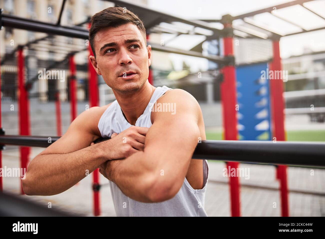Strong handsome guy training alone on sports ground Stock Photo - Alamy