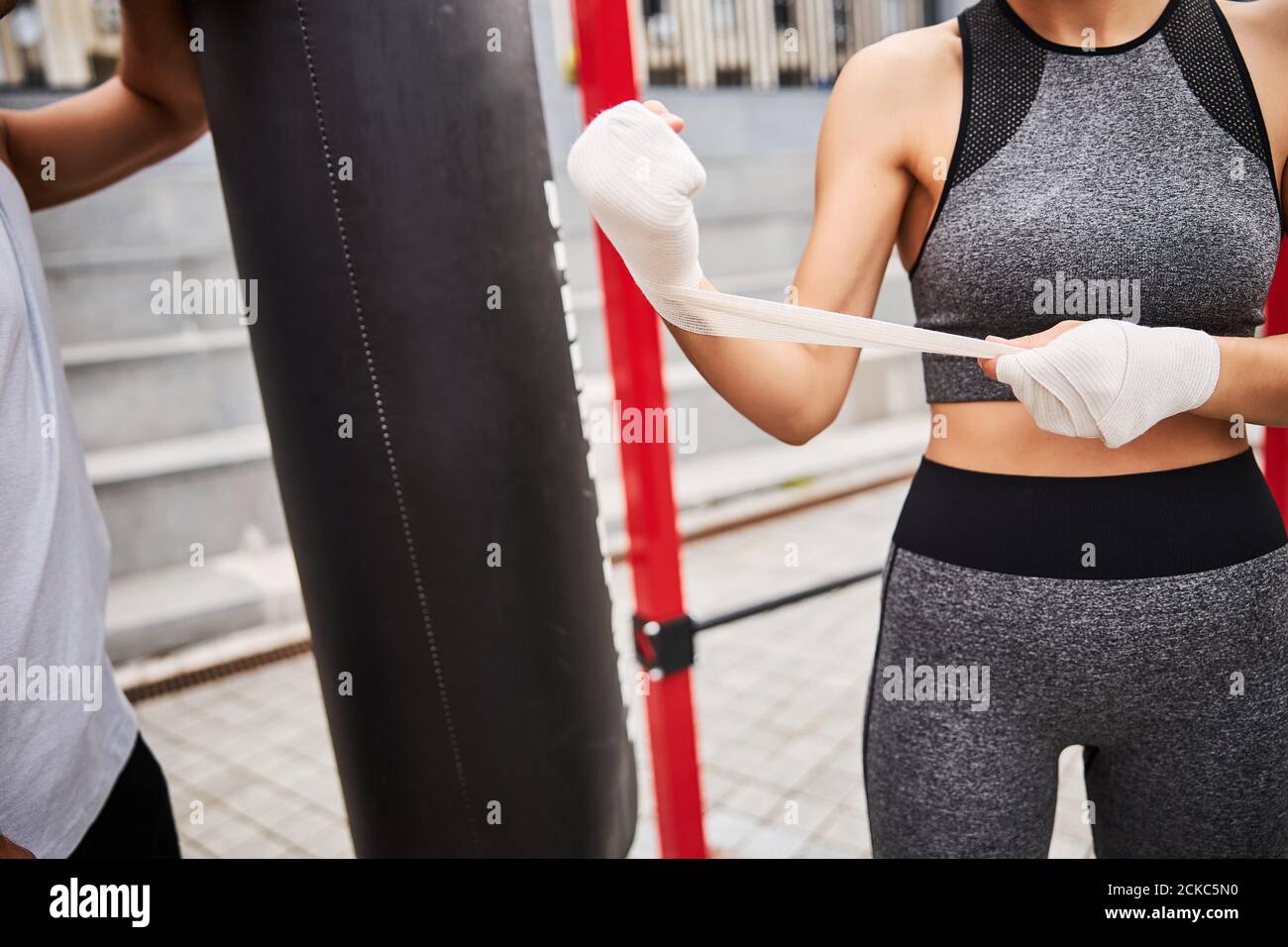 Woman preparing for boxing training with couch Stock Photo - Alamy