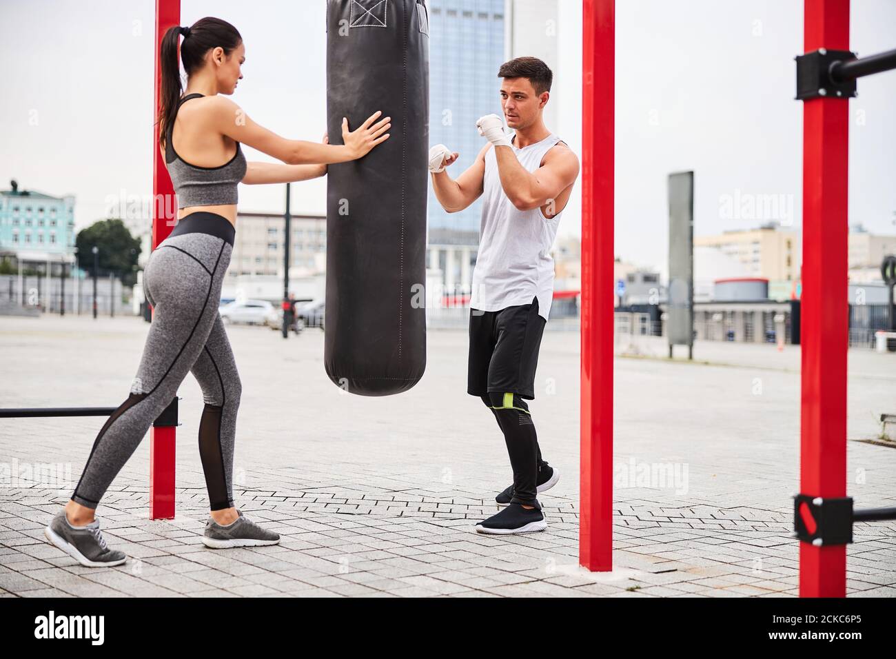 Young athletic couple boxing together in street sports ground Stock ...
