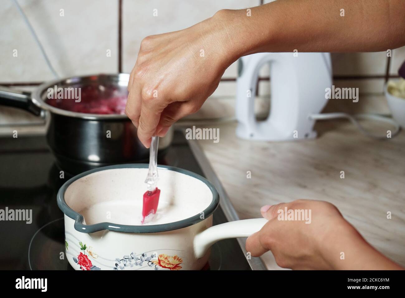 Cooking milk in the kitchen Stock Photo - Alamy