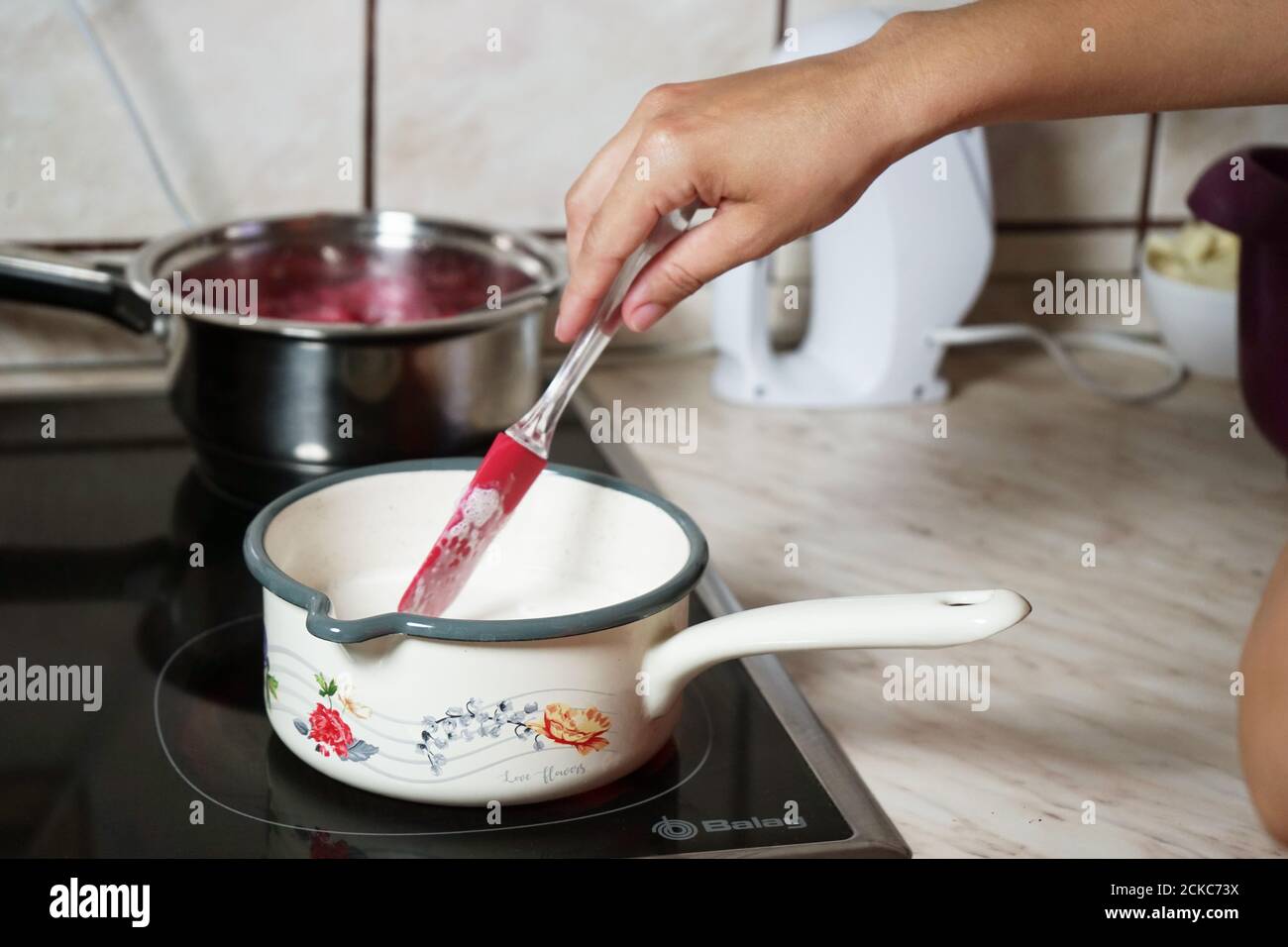 Cooking milk in the kitchen Stock Photo - Alamy