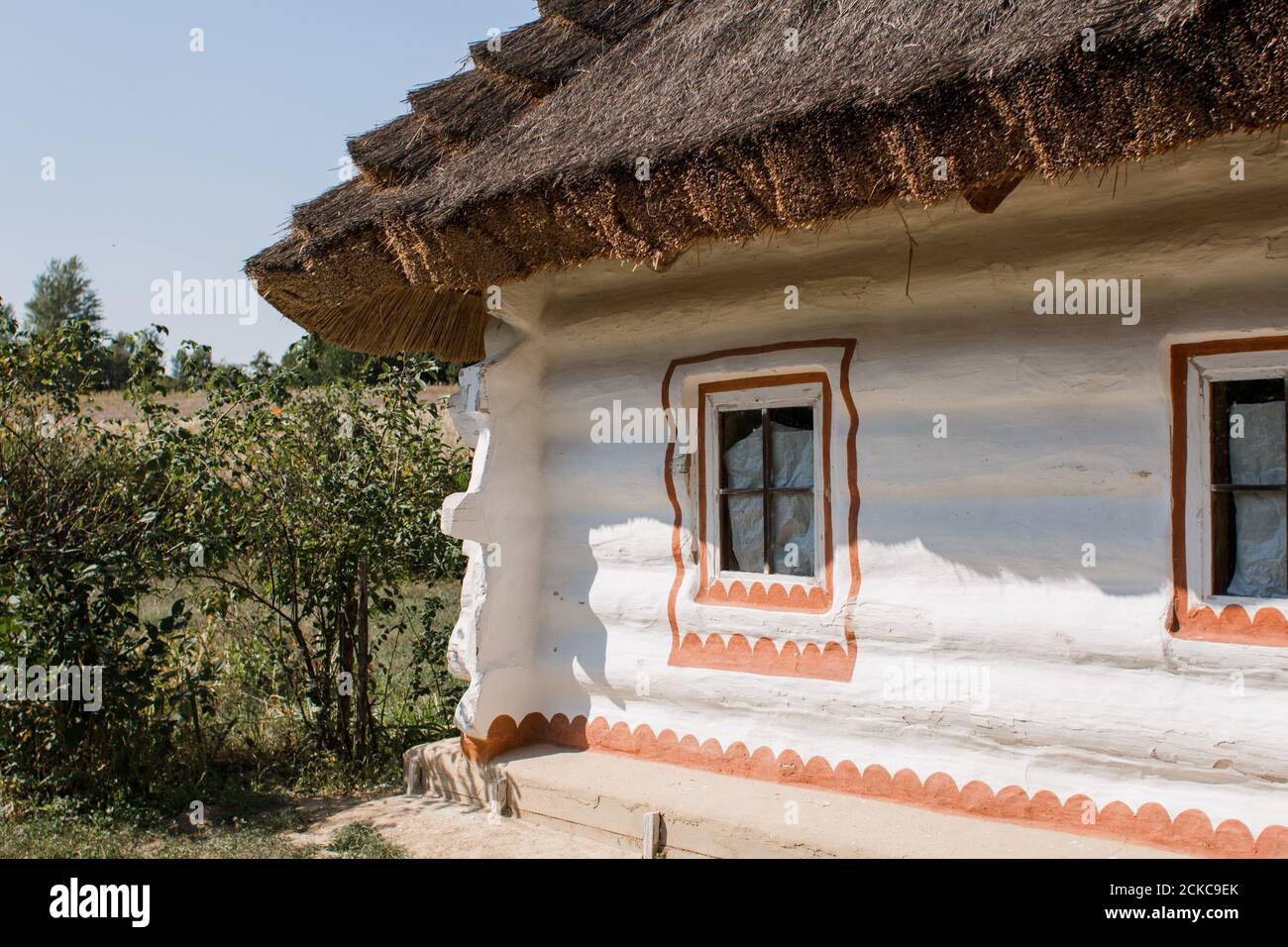 a white slavic house with a thatched roof Stock Photo - Alamy