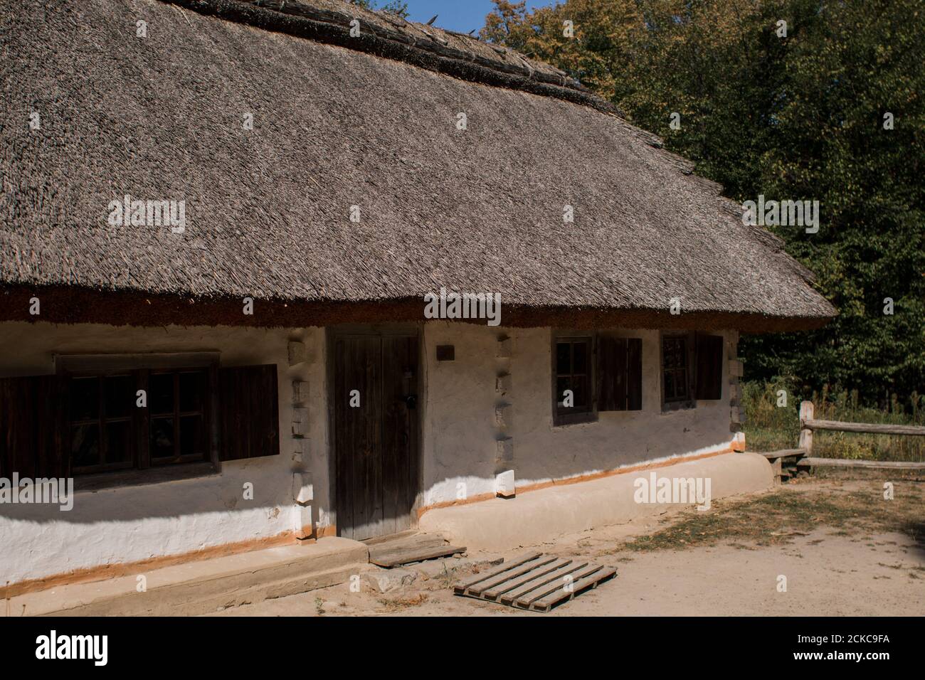 a white slavic house with a thatched roof Stock Photo - Alamy