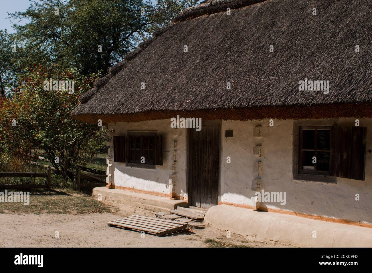 a white slavic house with a thatched roof Stock Photo - Alamy