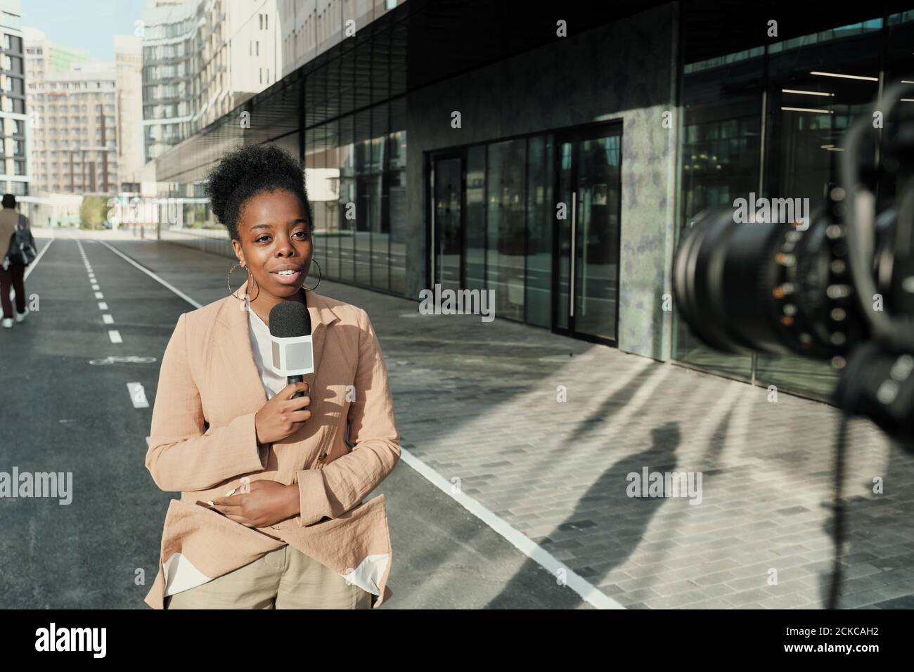 African news reporter with microphone live broadcasting on street Stock ...