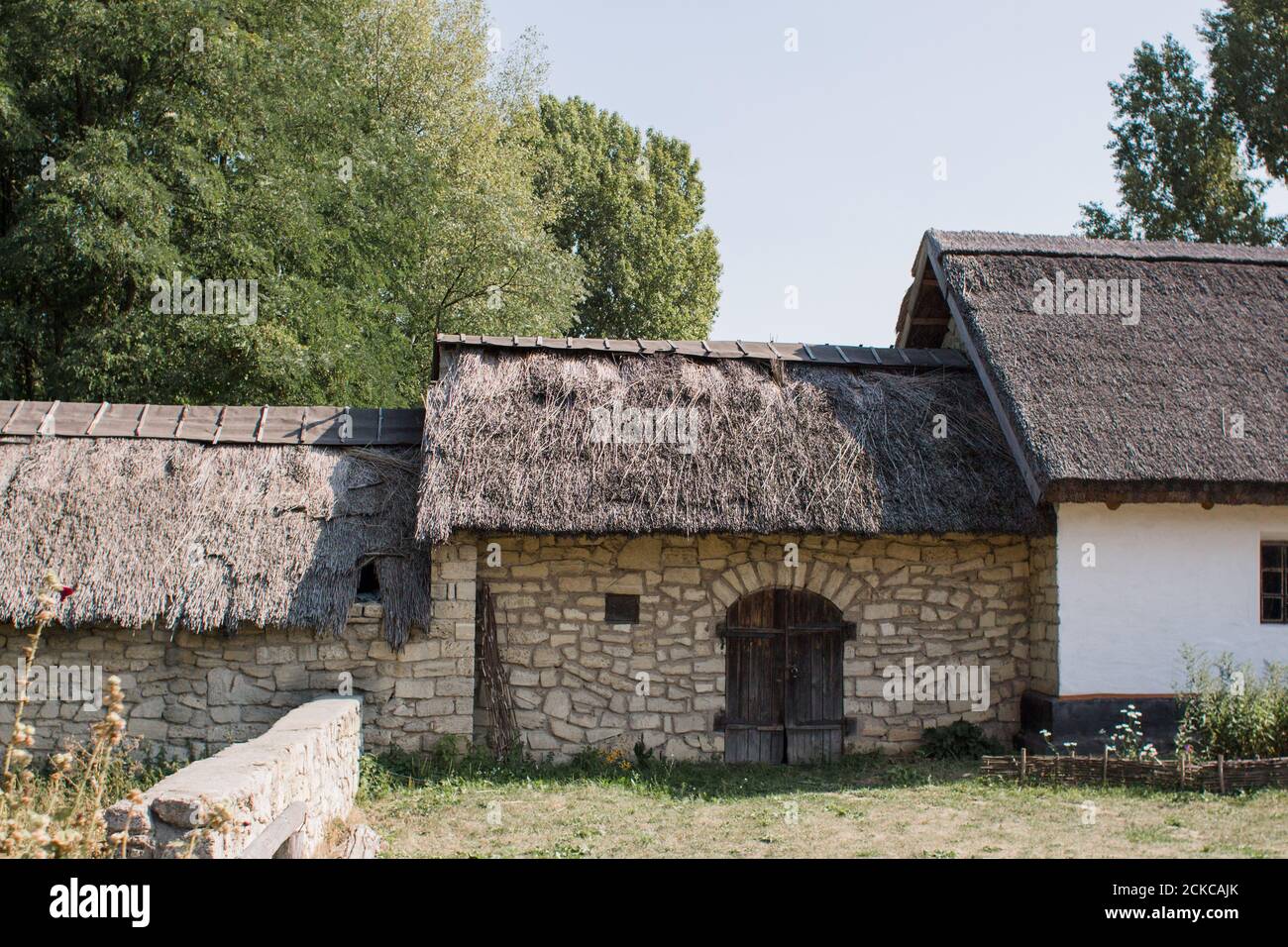old stone buildings with wooden roof in forest Stock Photo - Alamy