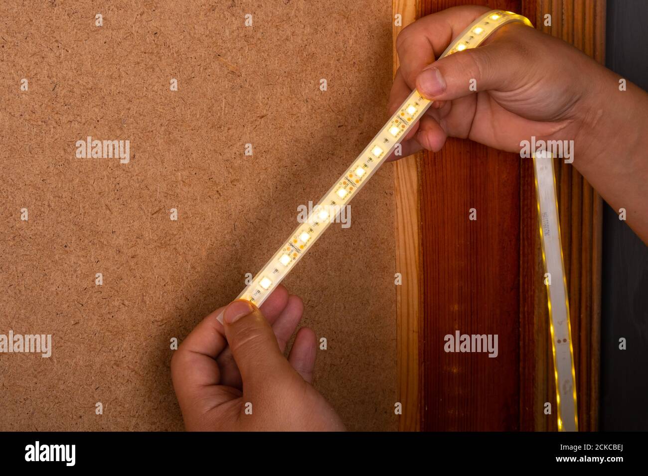 installation of LED strip on the door close up Stock Photo - Alamy