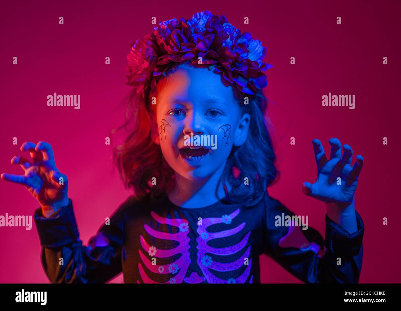 Happy Halloween! Cute little witch at party in colorful lighting Stock ...