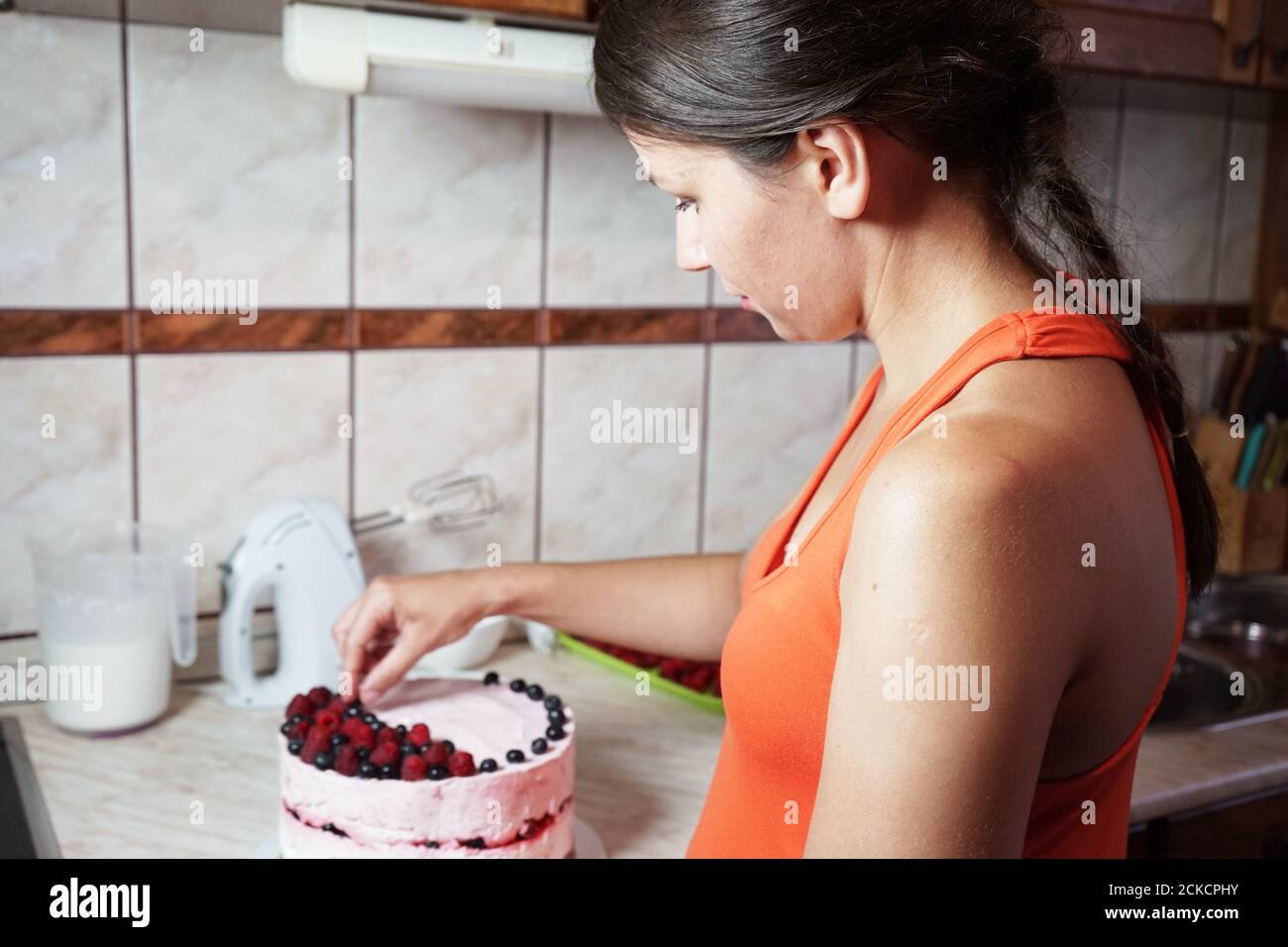 Woman decorates cake in home hi-res stock photography and images - Alamy
