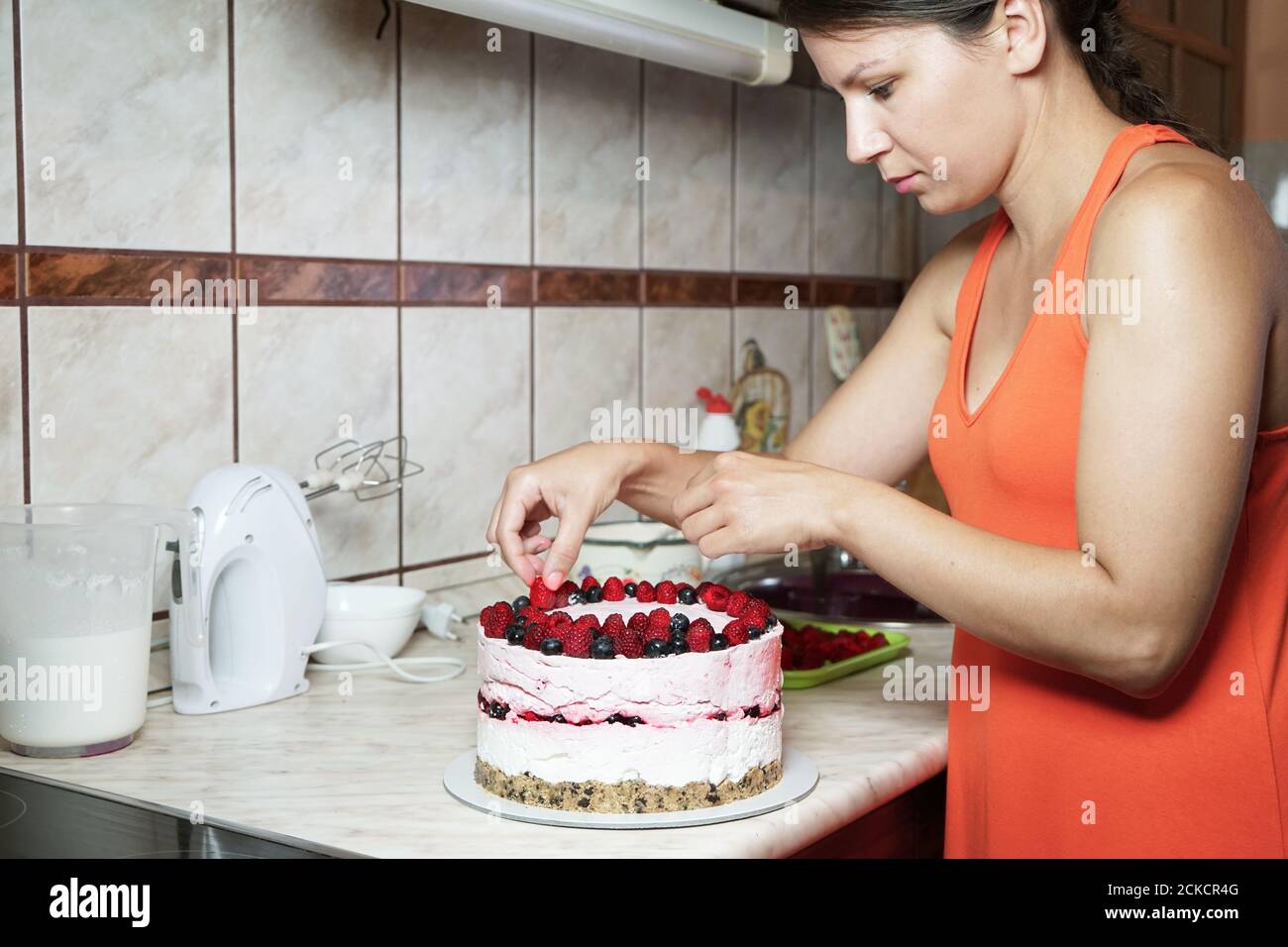 Woman decorates cake in home hi-res stock photography and images - Alamy