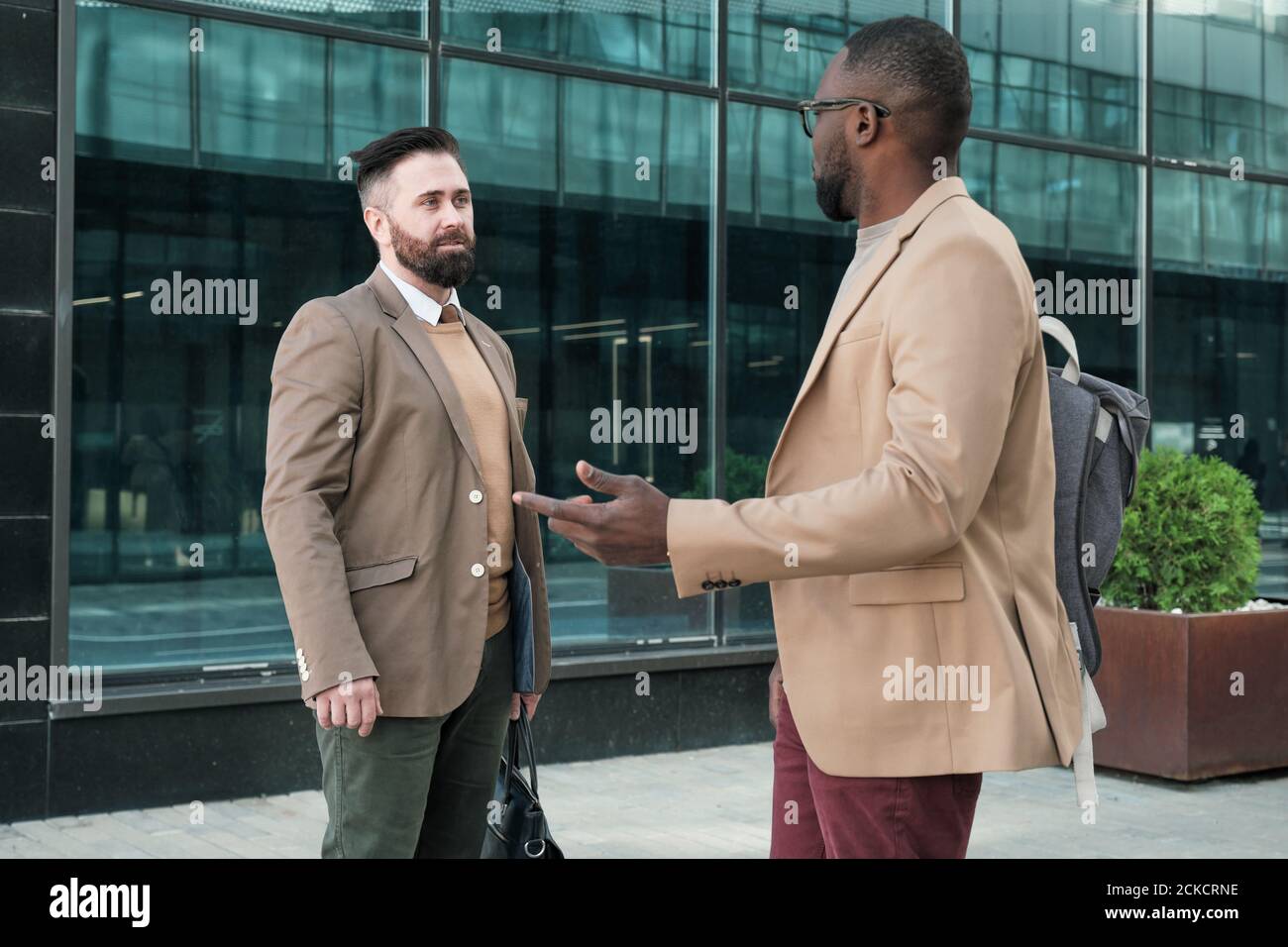 Two businessmen talking to each other hi-res stock photography and ...