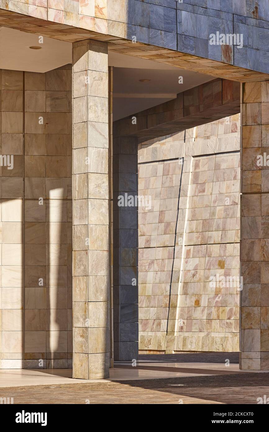 Stone tiles building facade with columns. Architecture and construction ...