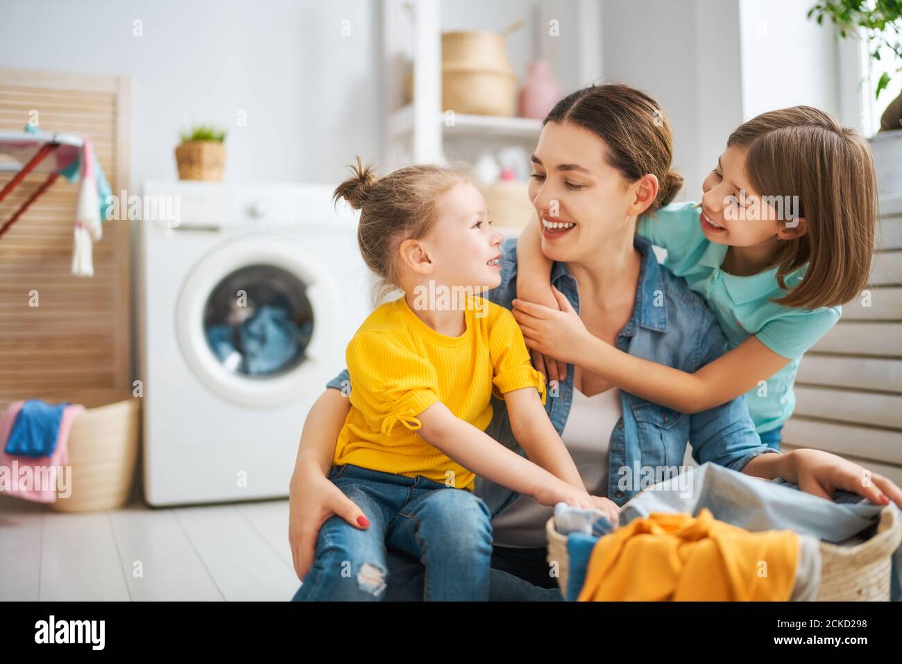 Beautiful young woman and child girl little helper are having fun and ...