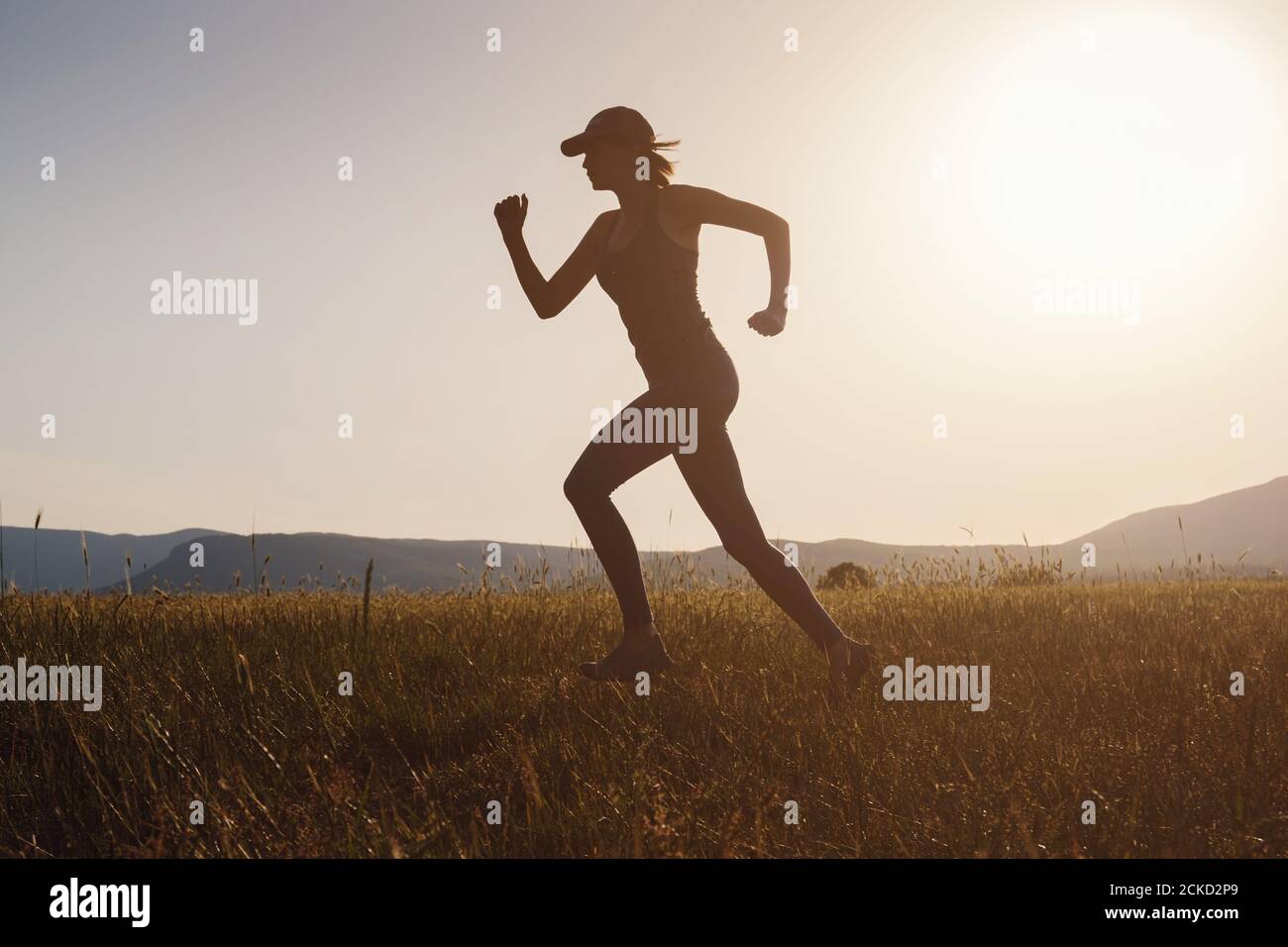 Jogging woman running in summer field at sunset. woman fitness ...