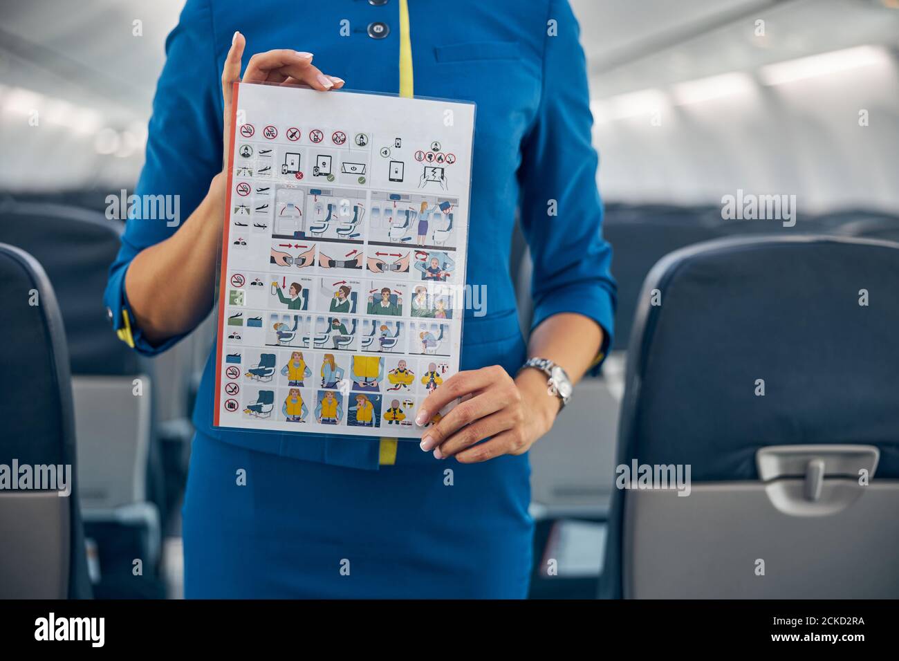 Close up image of flight safety instructions in woman hands on an ...