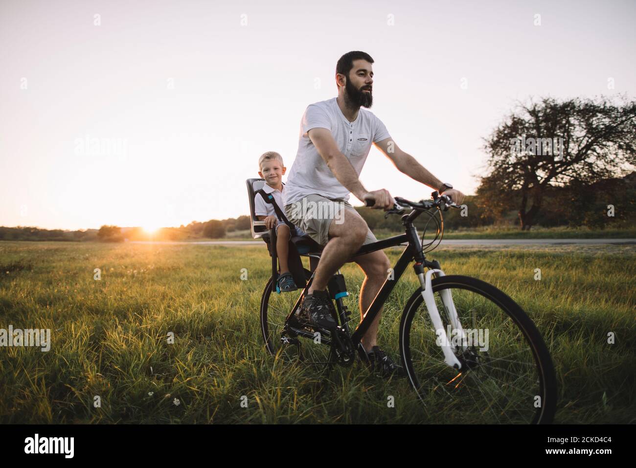 Father son cycling sunset hi-res stock photography and images - Alamy