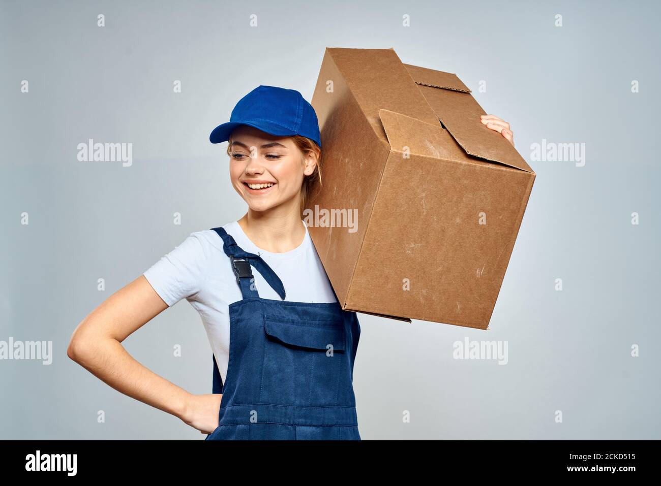 Woman in working uniform box packing service lifestyle Stock Photo - Alamy