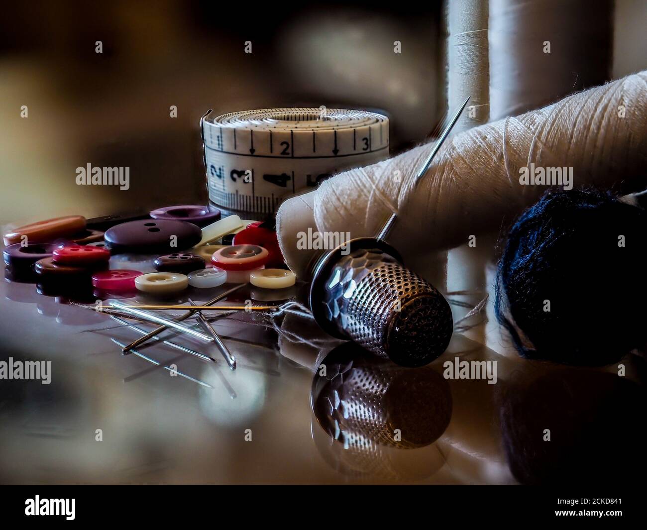 Still life of sewing items on a glass background Stock Photo - Alamy