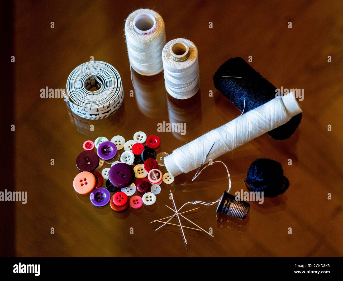 Still life of sewing items on a glass background Stock Photo - Alamy