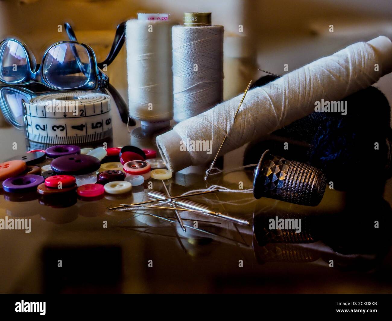Still life of sewing items on a glass background Stock Photo - Alamy