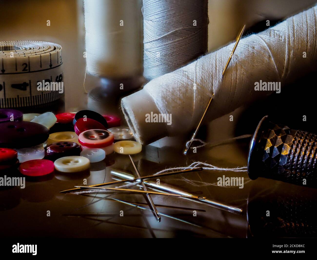 Still life of sewing items on a glass background Stock Photo - Alamy