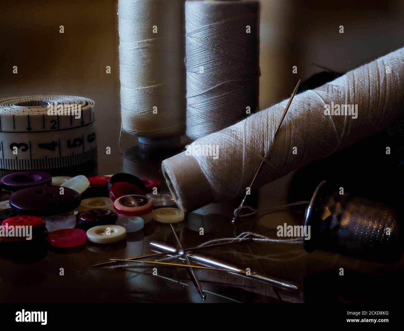 Still life of sewing items on a glass background Stock Photo - Alamy