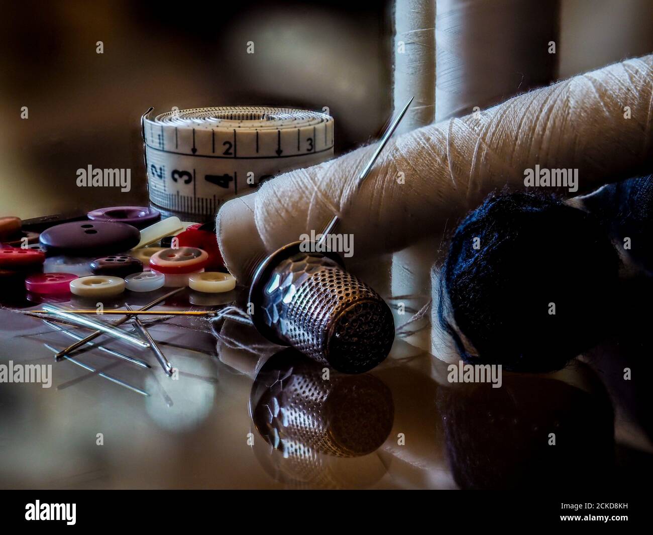 Still life of sewing items on a glass background Stock Photo - Alamy