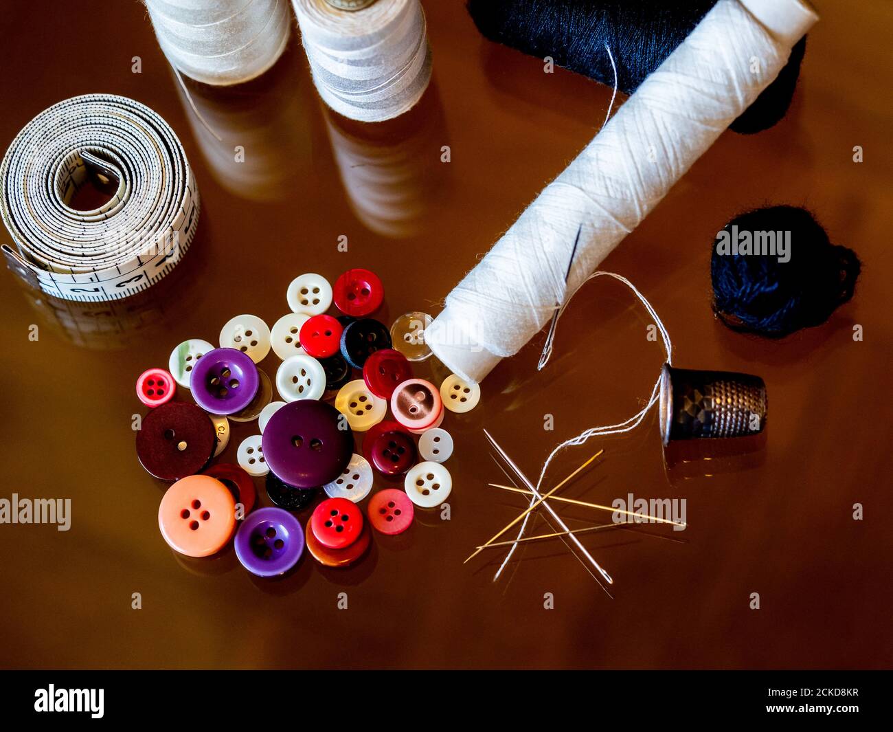 Still life of sewing items on a glass background Stock Photo - Alamy