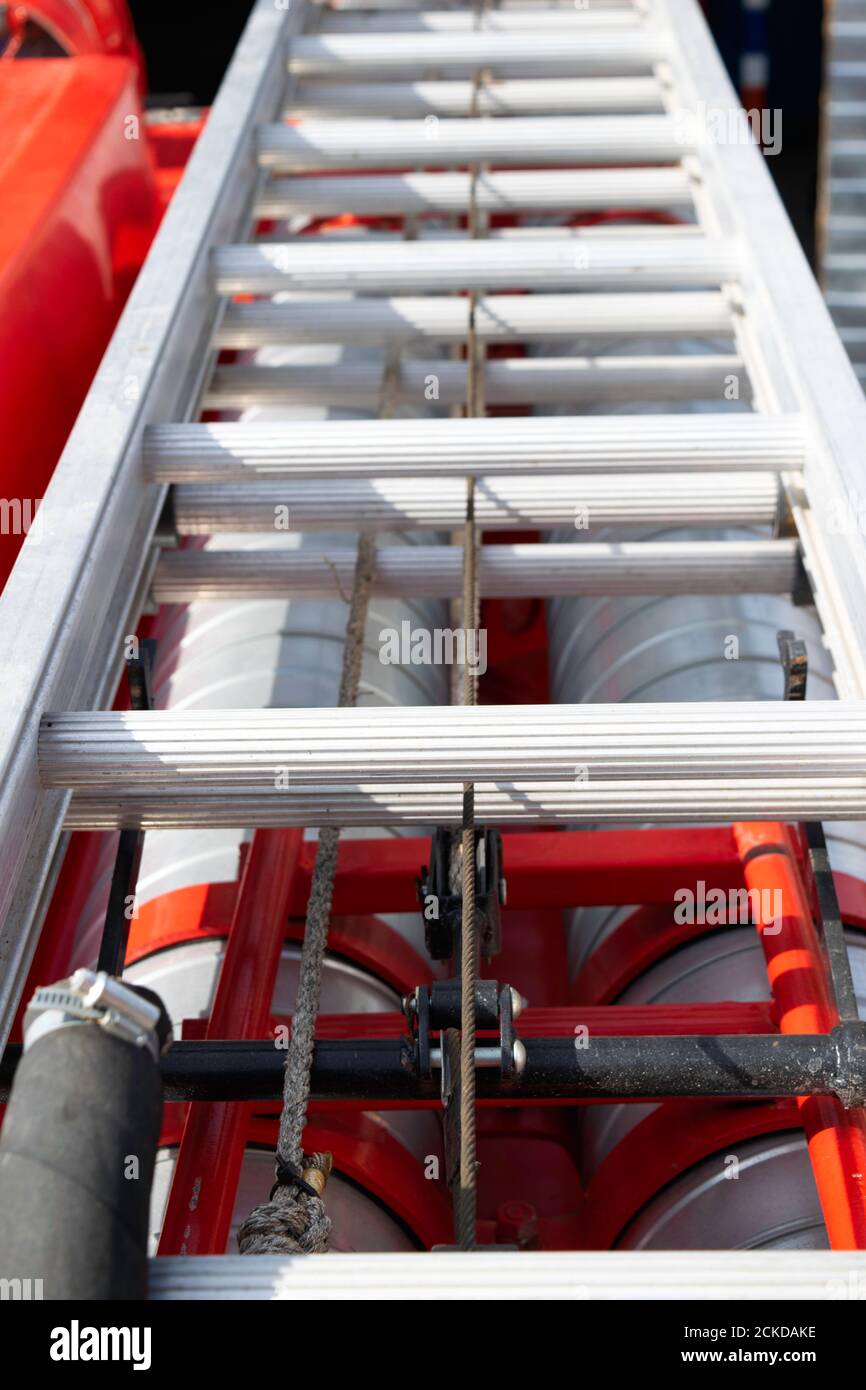 sliding fire three-knee ladder lies on a fire truck on the mounts ...