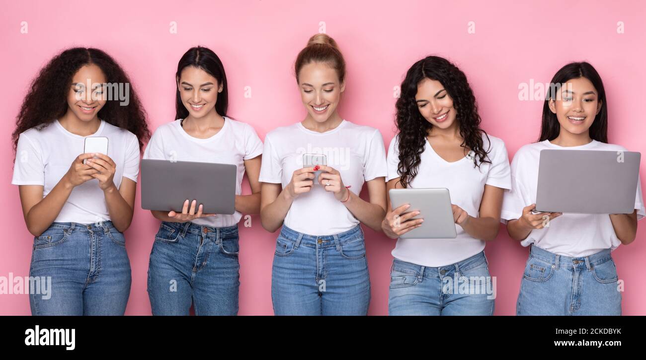 Multiracial Young Women Using Gadgets, Computers And Smartphones, Pink ...