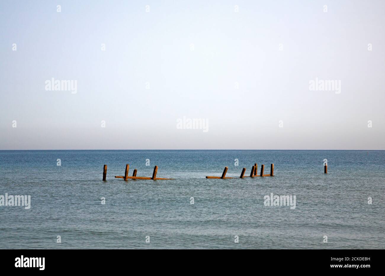The remains of old groynes and breakwaters now offshore due to coastal ...